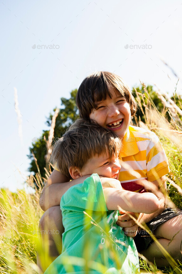Brothers Hugging Stock Photo by nualaimages | PhotoDune
