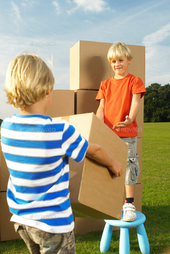 boy handing box to his brother Stock Photo by nualaimages | PhotoDune