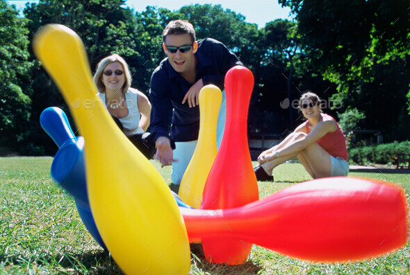 A group of friends playing skittles Stock Photo by nualaimages | PhotoDune