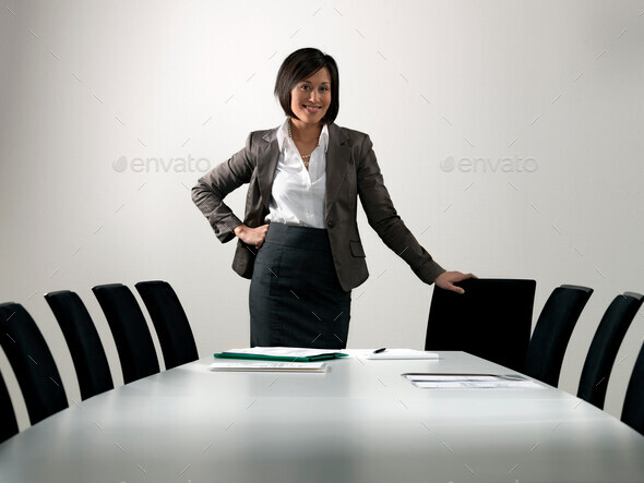 Business woman by conference table Stock Photo by nualaimages | PhotoDune