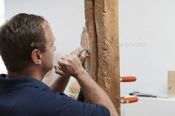 Worker chiseling figure from wood Stock Photo by nualaimages | PhotoDune