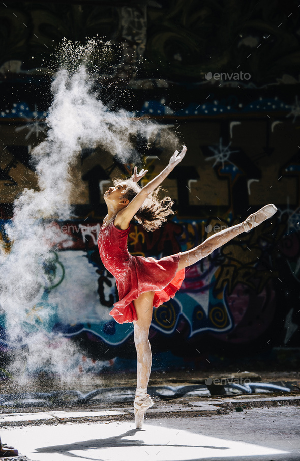 Ballet dancing girl scattering white powder in front of graffiti Stock ...