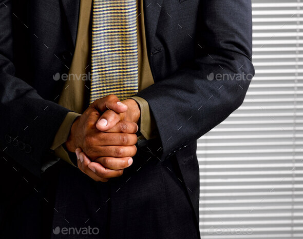 Business man wringing hands together Stock Photo by nualaimages | PhotoDune