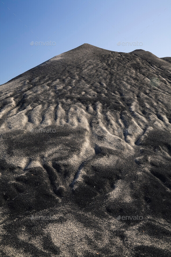 Mound of sand mixed with earth after heavy rain in commercial sand pit ...