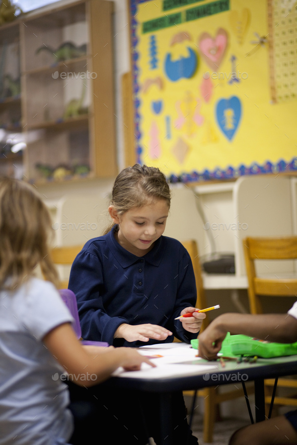 Children writing in classroom Stock Photo by ImageSourceCur | PhotoDune