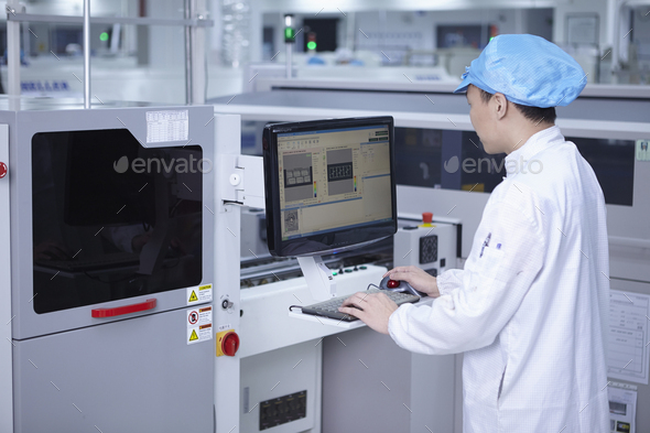 Worker using computer in factory that specialises in creating ...
