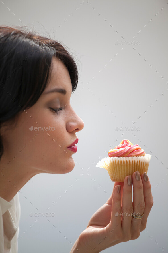 Close up of woman eating cupcake Stock Photo by ImageSourceCur | PhotoDune