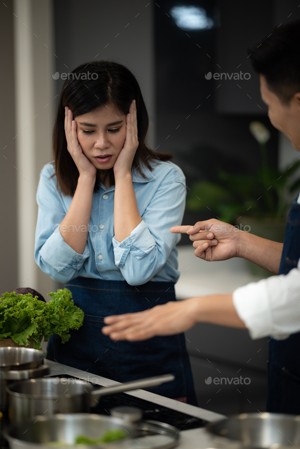 couple having accident when cooking in kitchen at home, meal food ...