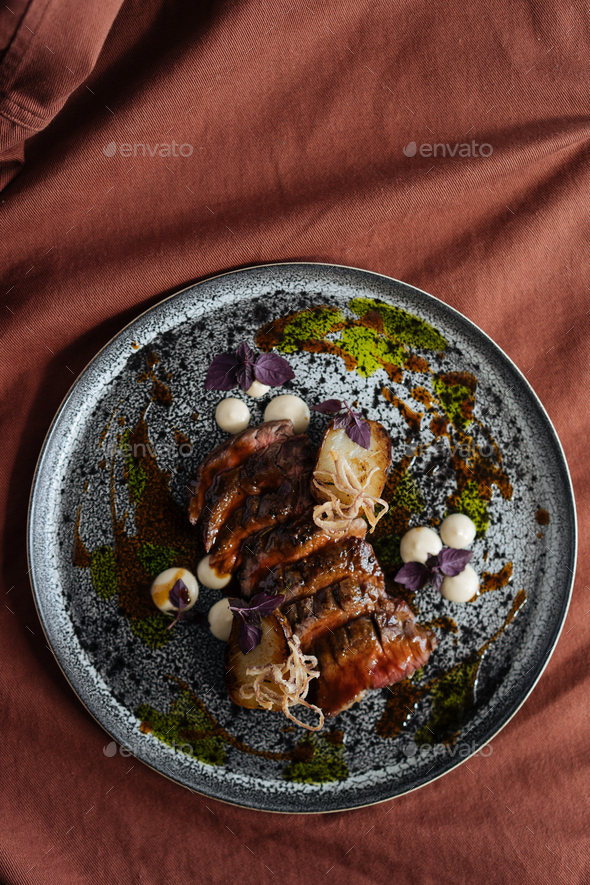 Top view of roasted meat in garnish Stock Photo by ADDICTIVE_STOCK