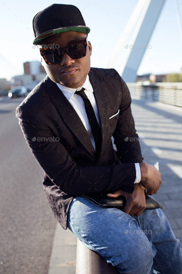 Fashion young man posing with a trendy outfit in the street. Stock ...