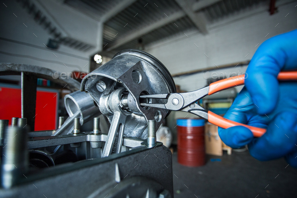 Mechanic fixing a compressor engine Stock Photo by ADDICTIVE_STOCK