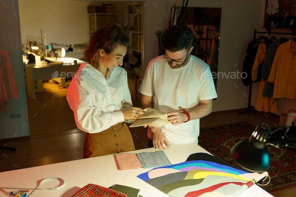 Dressmakers choosing cloth fabric for clothes collection. Seamstress ...