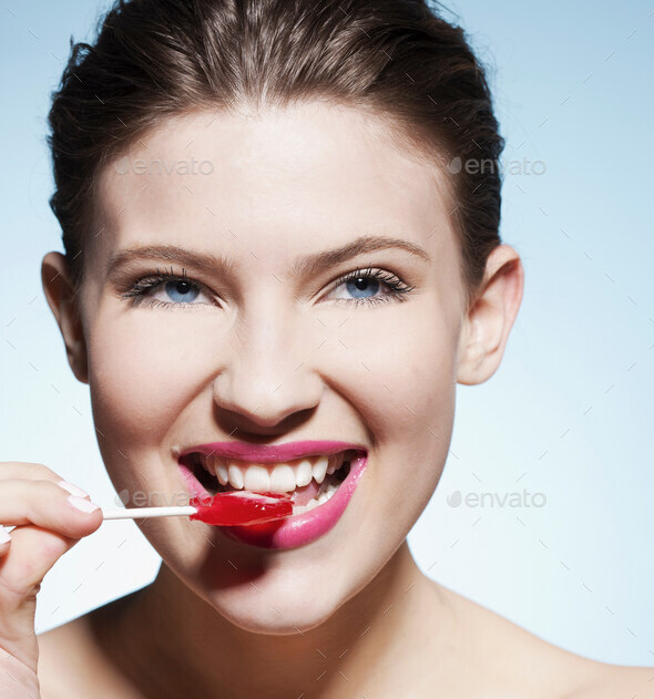 Smiling woman eating lollipop Stock Photo by Image-Source | PhotoDune