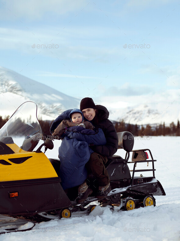 Mother and baby on Snowmobile Stock Photo by Image-Source | PhotoDune