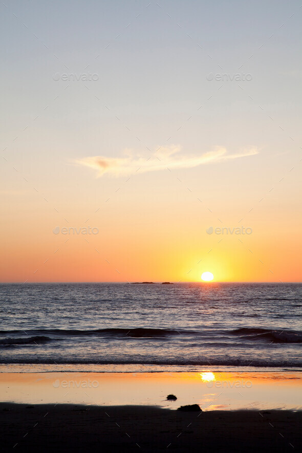 Sun setting over ocean on beach Stock Photo by Image-Source | PhotoDune