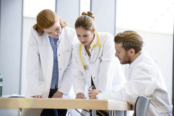 Group of doctors having discussion Stock Photo by Image-Source | PhotoDune