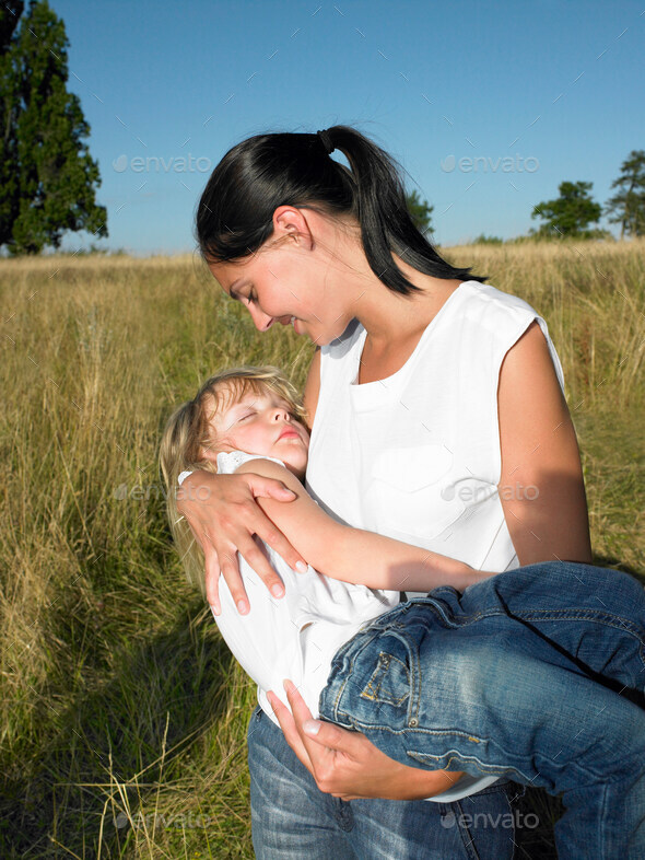Mother carrying her sleeping daughter Stock Photo by Image-Source ...