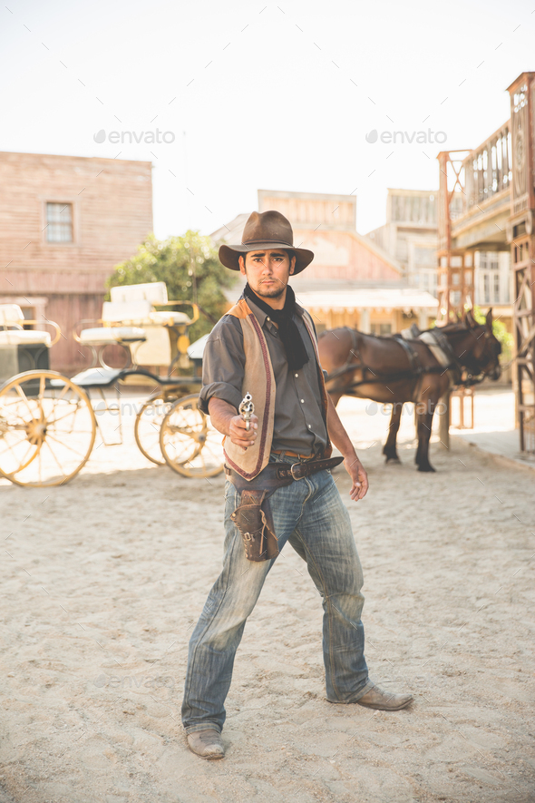 Portrait of cowboy pointing gun on wild west film set, Fort Bravo ...