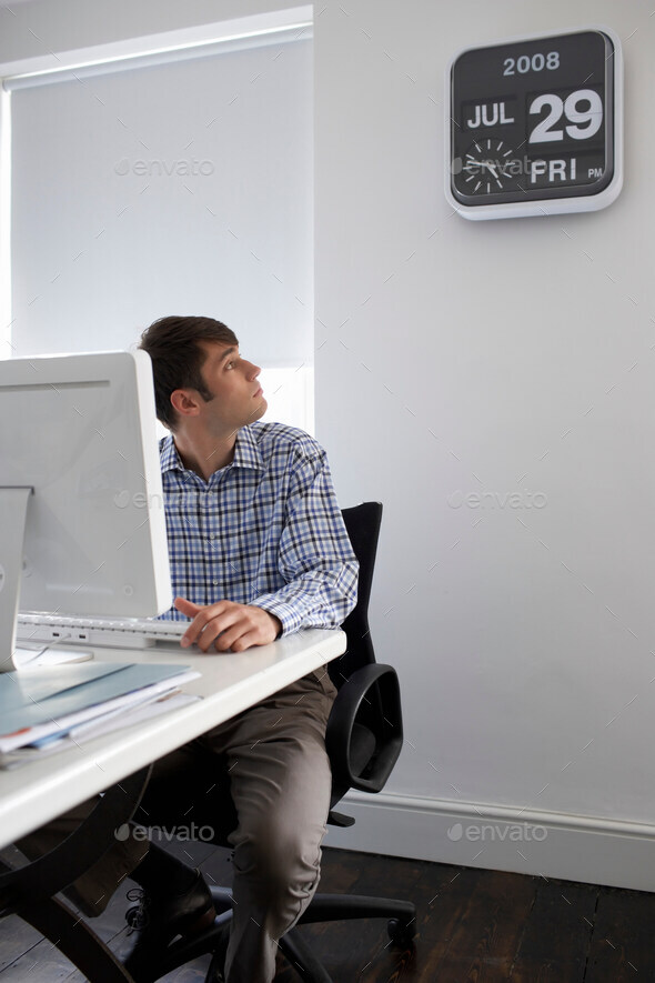 Office worker looking at clock Stock Photo by Image-Source | PhotoDune