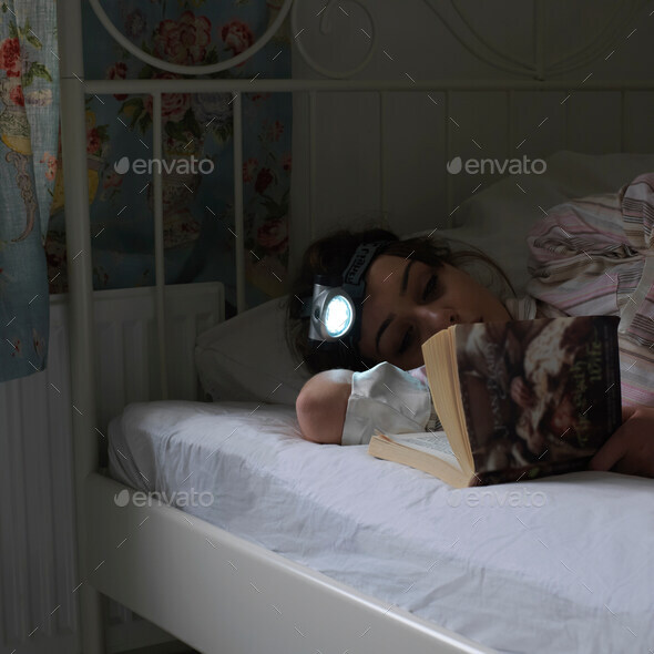 Reading book with head torch Stock Photo by Image-Source | PhotoDune