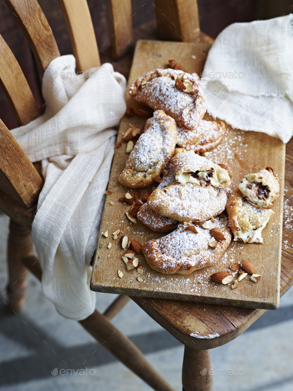 Cannoli calzone dusted with sugar, on serving board Stock Photo by ...