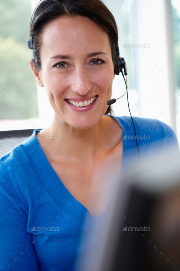 Receptionist behind her desk, smiling Stock Photo by Image-Source ...