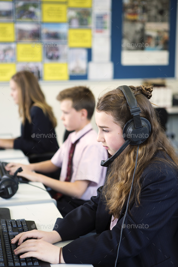 Students using computer in classroom Stock Photo by Image-Source ...