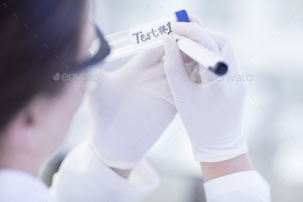 Laboratory worker writing details on test tube, rear view Stock Photo ...