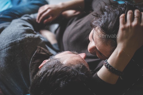 Couple embracing, face to face, overhead view Stock Photo by Image-Source