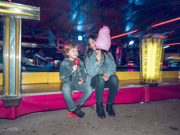 Mother and son with snacks on funfair Stock Photo by ADDICTIVE_STOCK