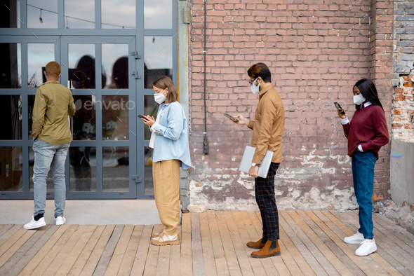 Students waiting in queue at university campus Stock Photo by RossHelen