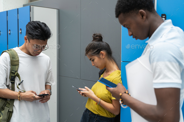 Multi-ethnic teenager student friends using smart mobile phones in high ...