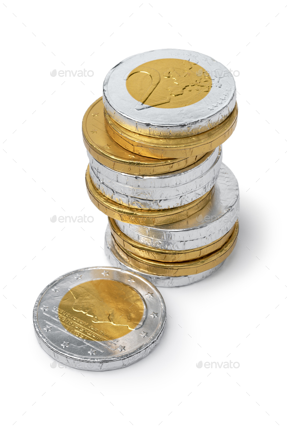 Pile of golden and silver chocolate coins close up on white background ...