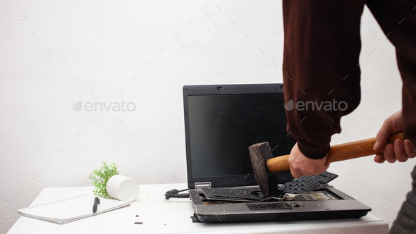 man office worker smashed a laptop, destroyed a computer. Anger, hatred ...