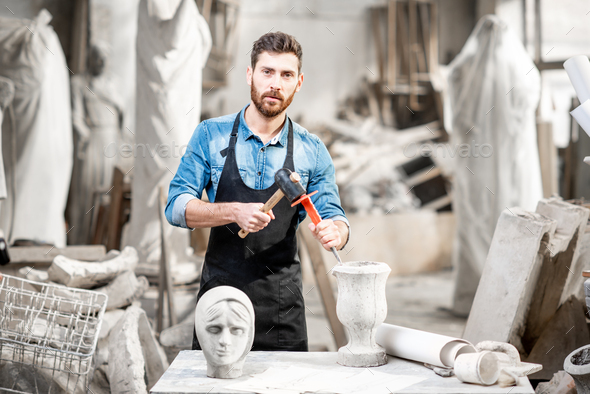 Sculptor working with sculptuers in the studio Stock Photo by RossHelen
