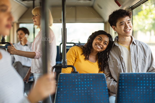 Happy smiling guy and lady taking bus together Stock Photo by Prostock ...