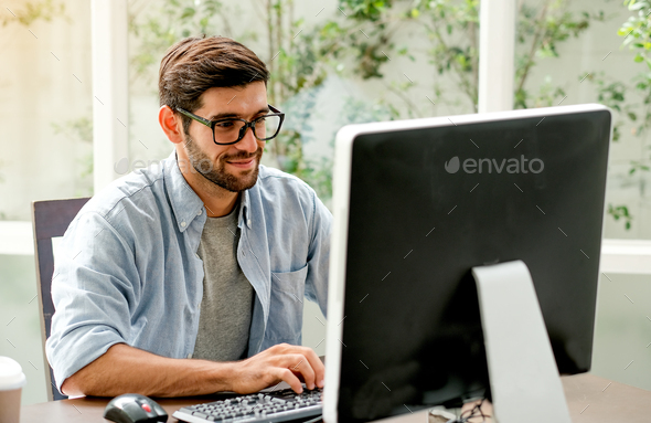 Handsome engineer man is typing computer on the table in the office ...