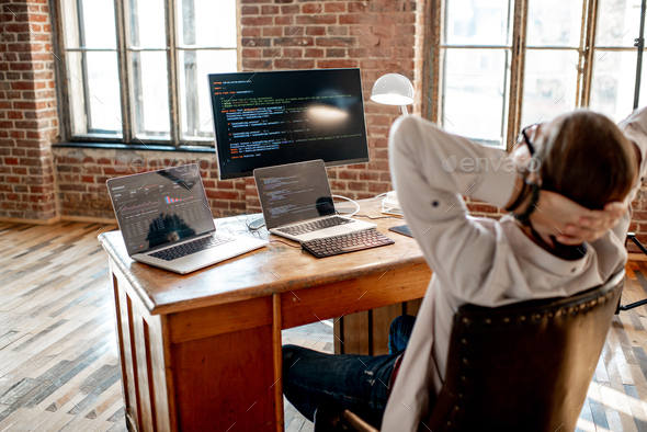 Programmer working with program code Stock Photo by RossHelen | PhotoDune