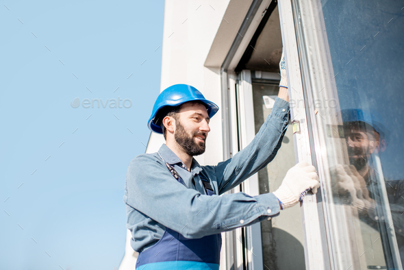 Workman mounting windows Stock Photo by RossHelen | PhotoDune