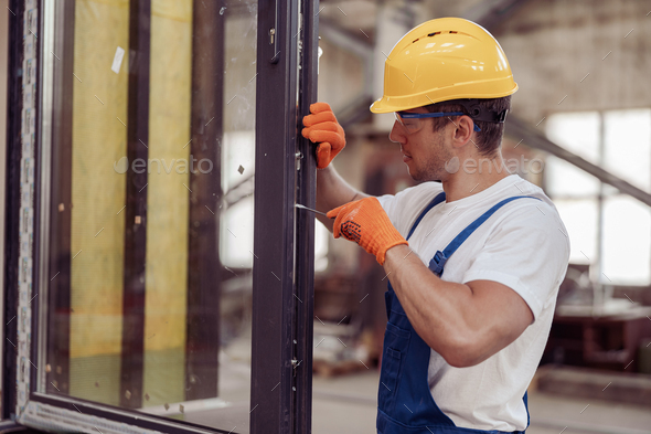 Male worker fixing door in building under construction Stock Photo by ...