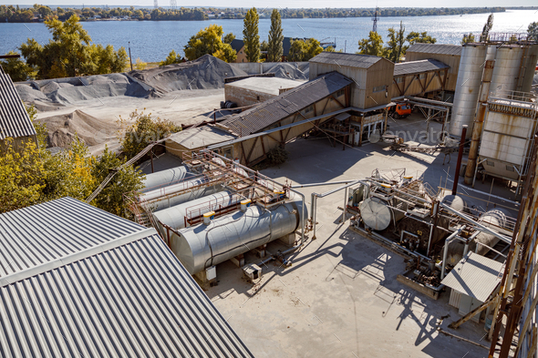 Industrial site near river with facility complex Stock Photo by ...