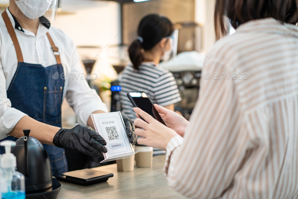 Close up of customer make easy contactless, scanning QR code to pay for ...