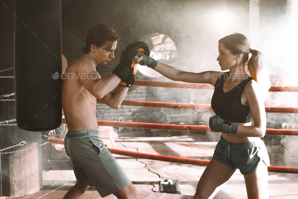 Boxing couple sporty muscular young man and woman boxing together ...