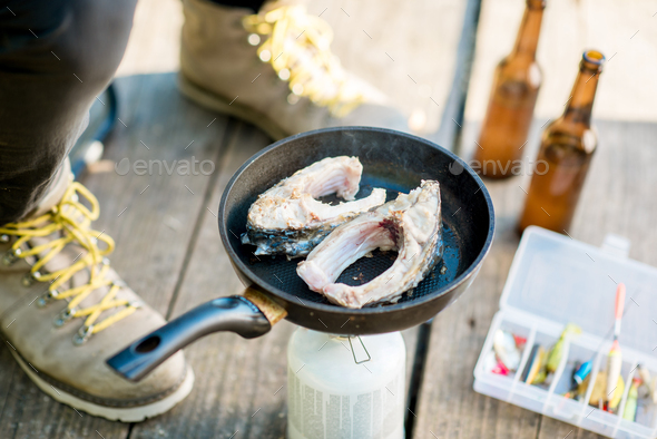 Frying fish outdoors Stock Photo by RossHelen | PhotoDune