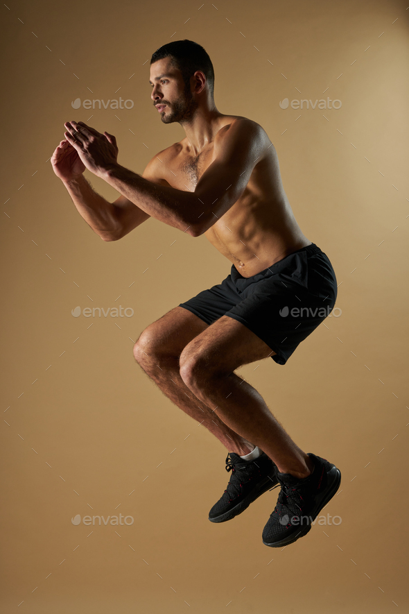 Handsome bearded male getting in shape while doing different sports ...