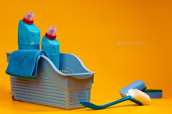 Home cleaning tools on yellow studio background Stock Photo by FabrikaPhoto