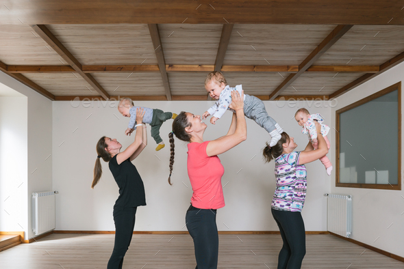 Mothers lifting babies in gym Stock Photo by ADDICTIVE_STOCK | PhotoDune