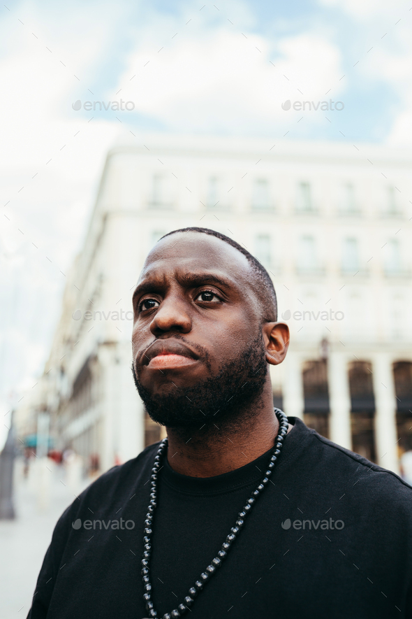 Portrait of serious black man looking away Stock Photo by ADDICTIVE_STOCK