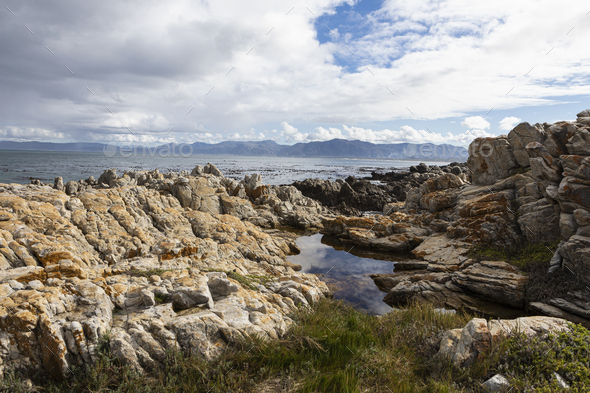 Rocky jagged coastline, rock pool and view out to the ocean Stock Photo ...