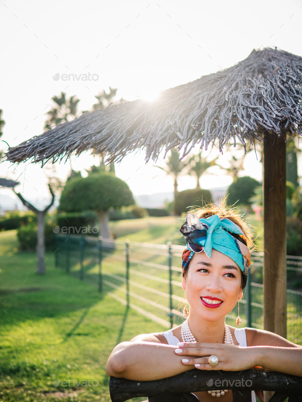 Young elegant chinese woman sunbathing Stock Photo by ADDICTIVE_STOCK